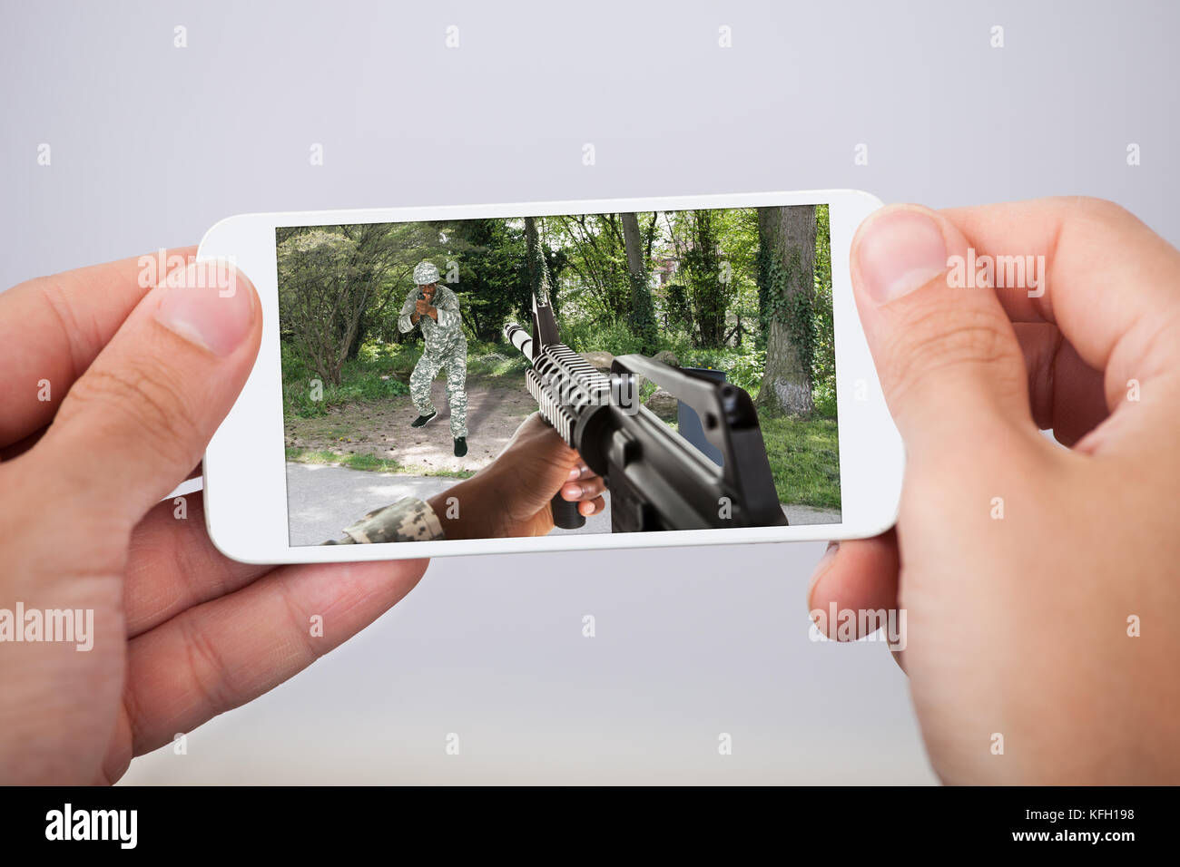 Closeup of man playing action game on smartphone Stock Photo - Alamy