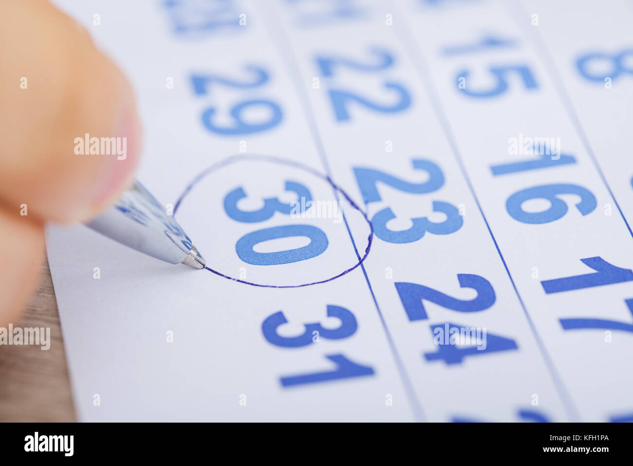 Cropped image of businessman marking date on calendar at desk Stock ...
