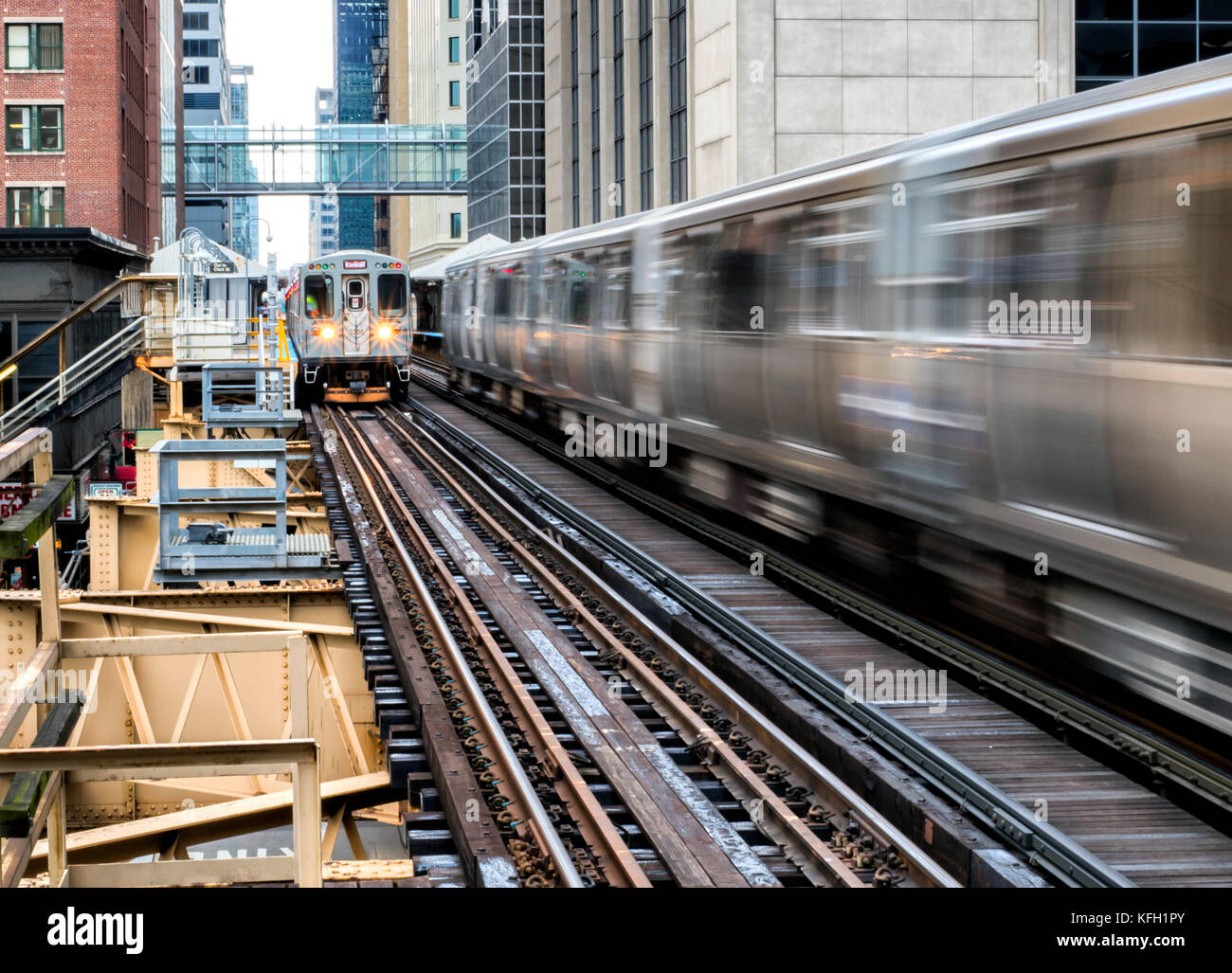 Moving Train on elevated tracks within buildings at the Loop, Glass and ...
