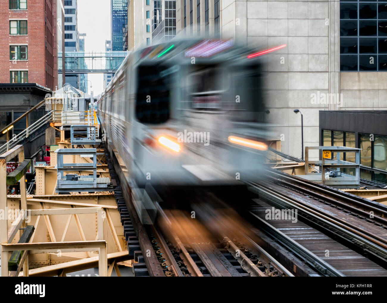 Moving Train on elevated tracks within buildings at the Loop, Glass and ...