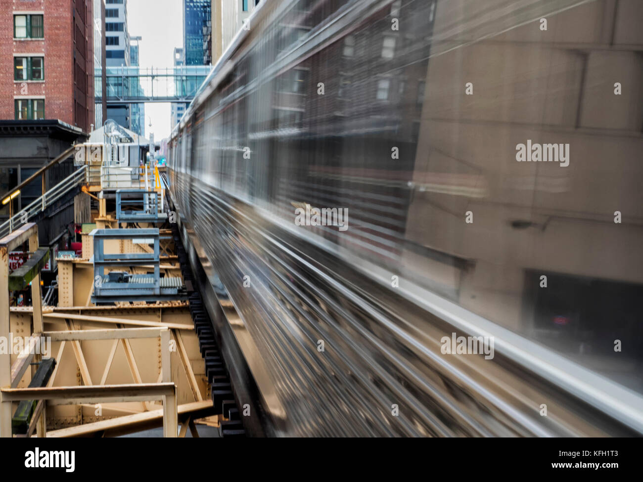 Moving Train on elevated tracks within buildings at the Loop, Glass and ...