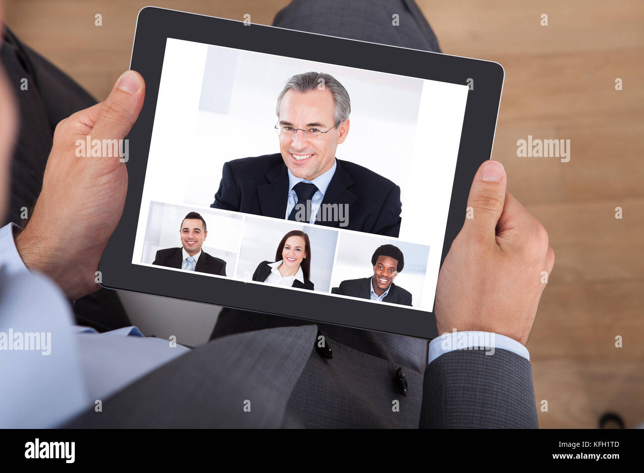 High angle view of businessman video conferencing with coworkers on ...