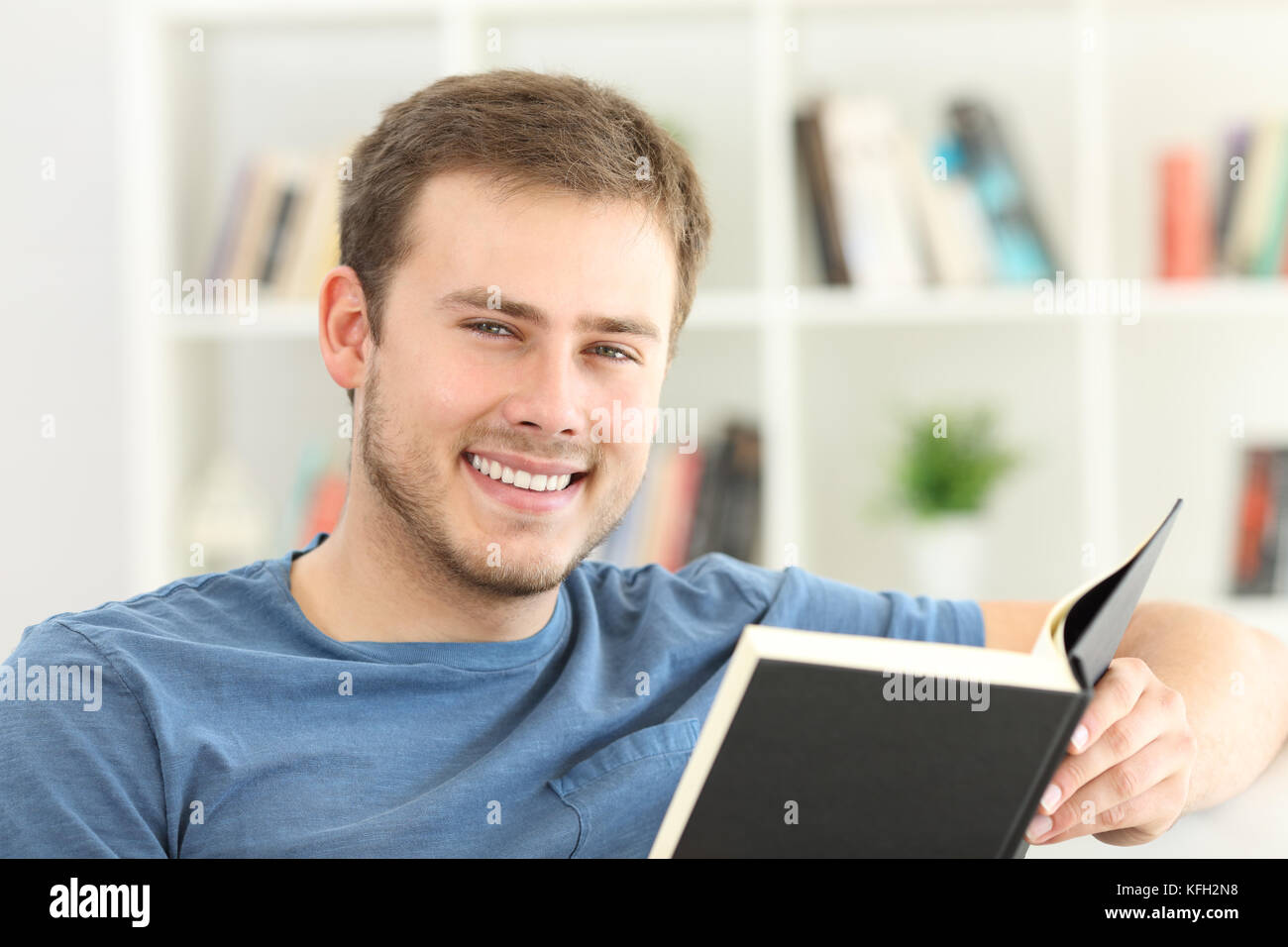 Boy laughing reading book hi-res stock photography and images - Alamy