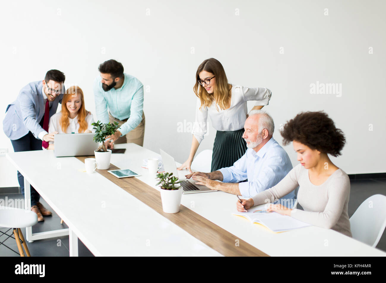 View of multiracial business people around table during staff meeting ...