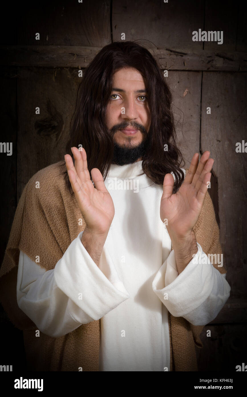 Portrait of a model in the role of Jesus Christ praying or preaching ...