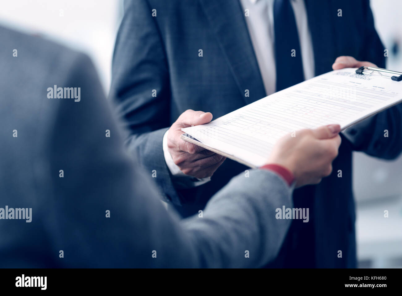 Close up of business people holding clipboard Stock Photo - Alamy