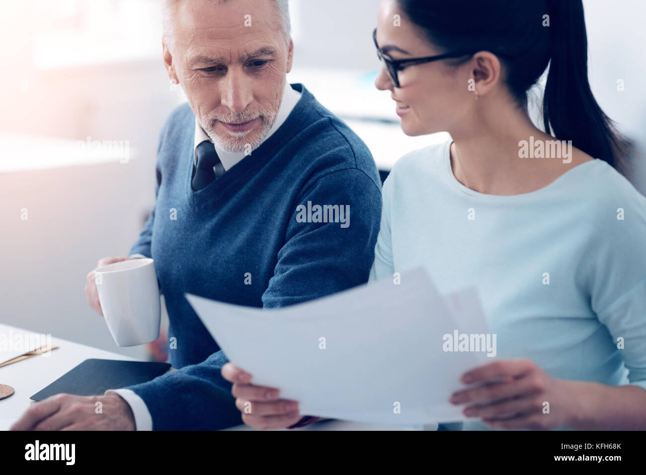 Mature businessman discussing paperwork hi-res stock photography and ...
