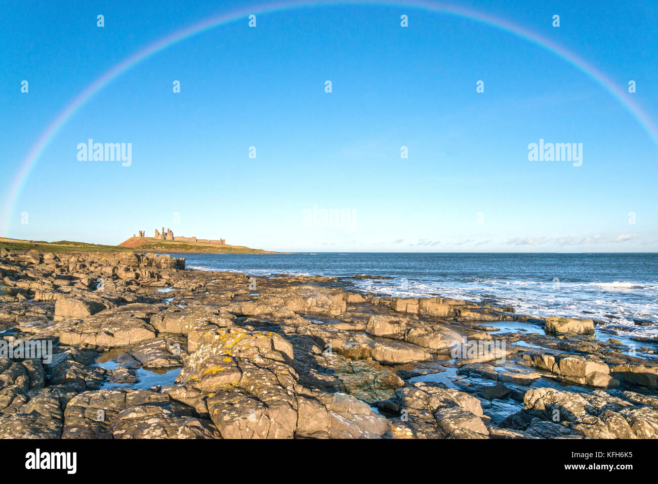 Rainbow over Dunstanburgh Castle Stock Photo - Alamy