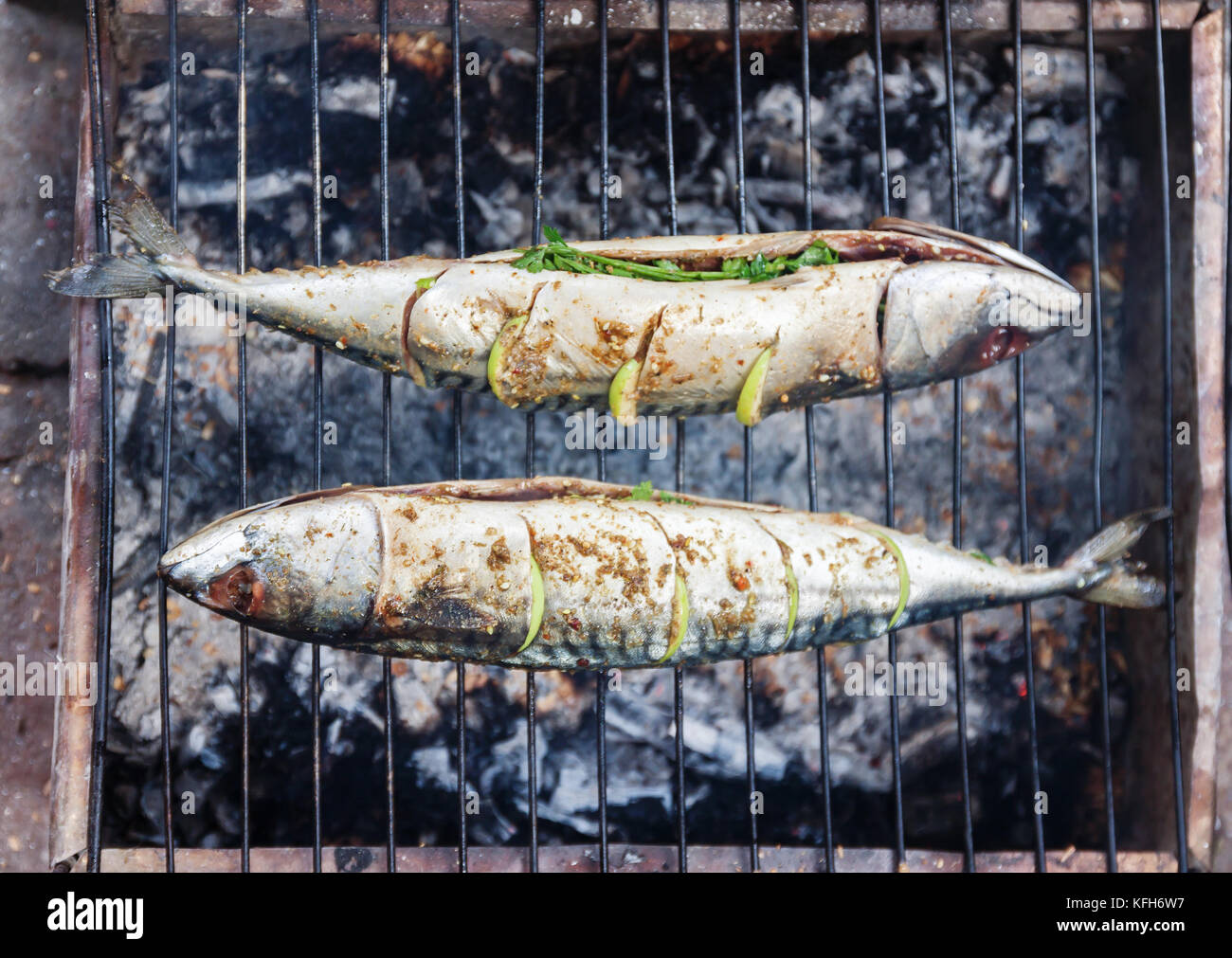 Grilled fish with spices on fire close up. Grilling fish dorado on ...
