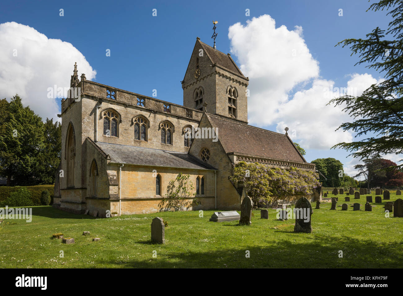 St Nicholas's church with wisteria on outside in spring, Hatherop, Cotswolds, Gloucestershire ...