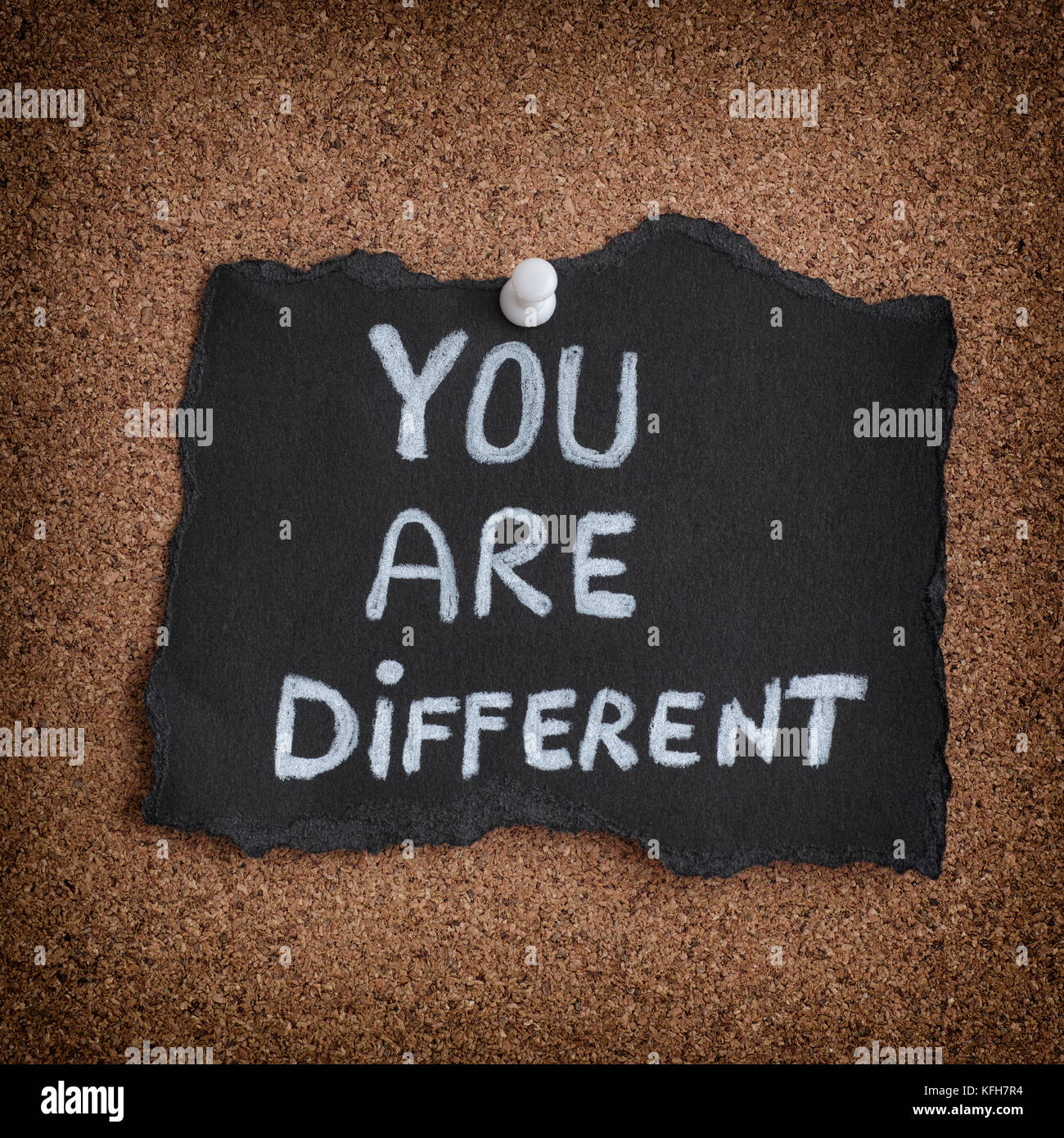 You are different. Piece of black paper with phrase You are different ...