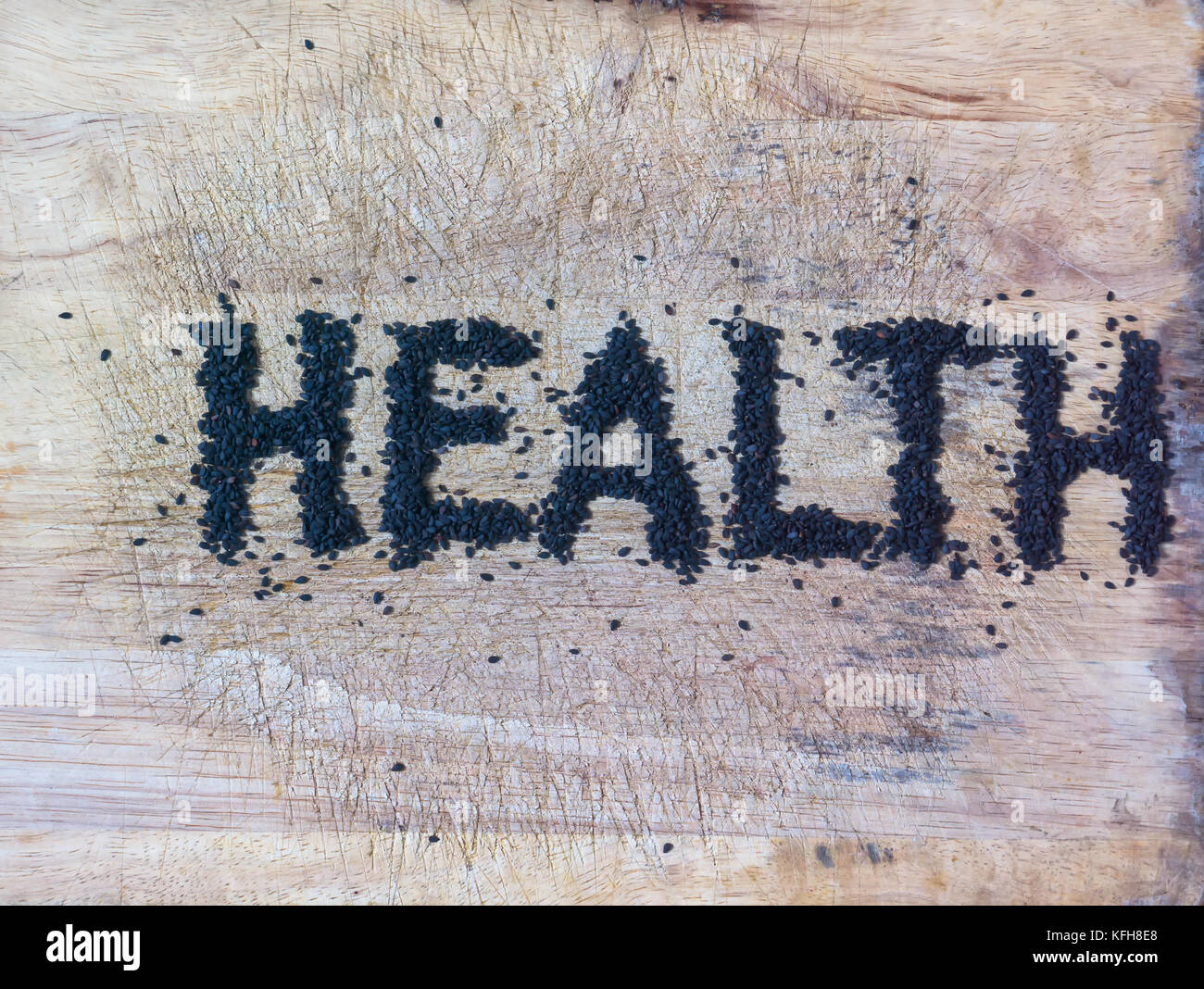 Black sesame seed in health wording on chopping block Stock Photo - Alamy