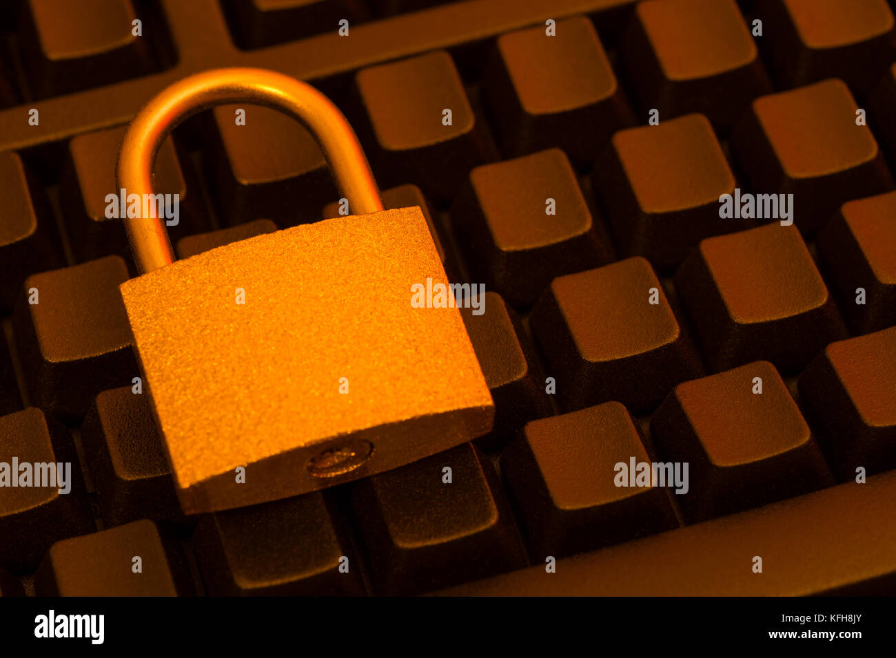 Small padlock on a black blanked keyboard - for cyber threat, cyber ...