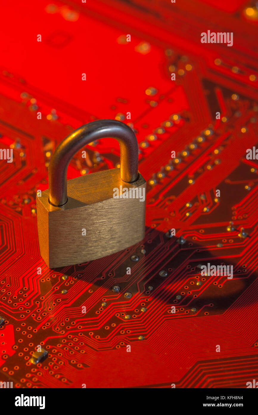 Small padlock on a red coloured circuitboard. For cyber security, data ...