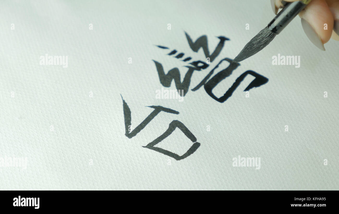 Woman's hands writing Chinese hieroglyph. Female hand holding a writing ...