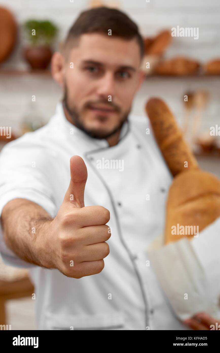 Young man working at his bakery Stock Photo - Alamy