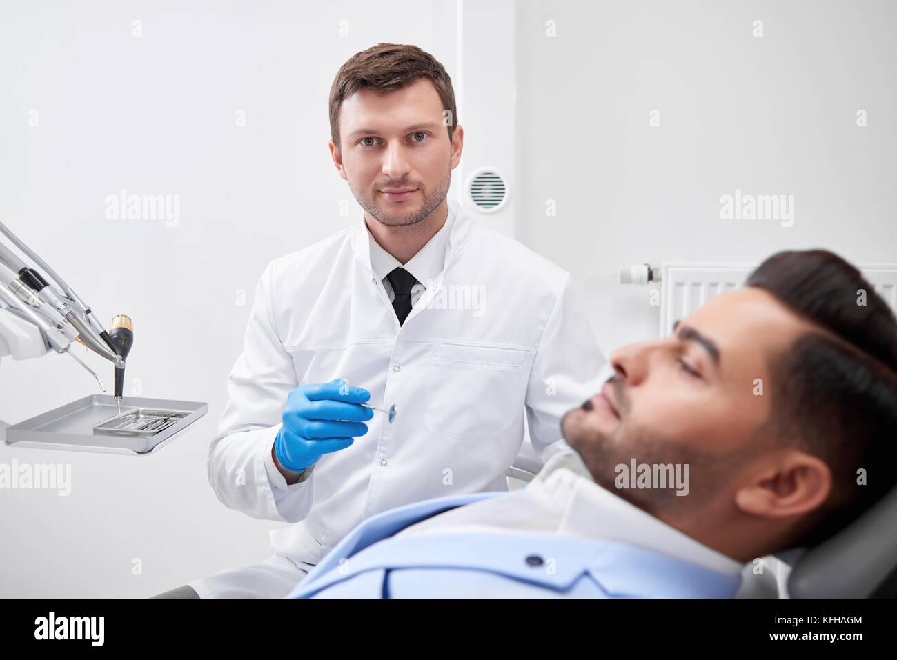 Young man visiting dentist Stock Photo - Alamy