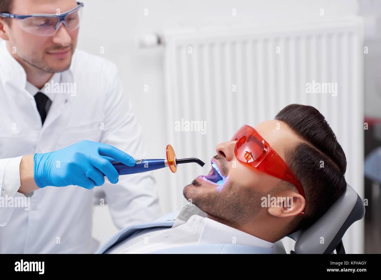Young man visiting dentist Stock Photo - Alamy