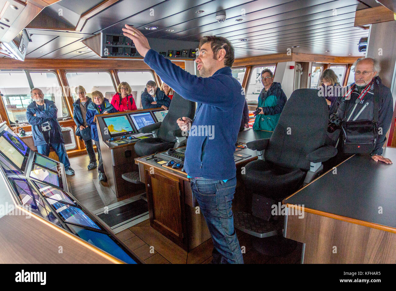 The skipper explaining the new technology on the bridge of the new ...