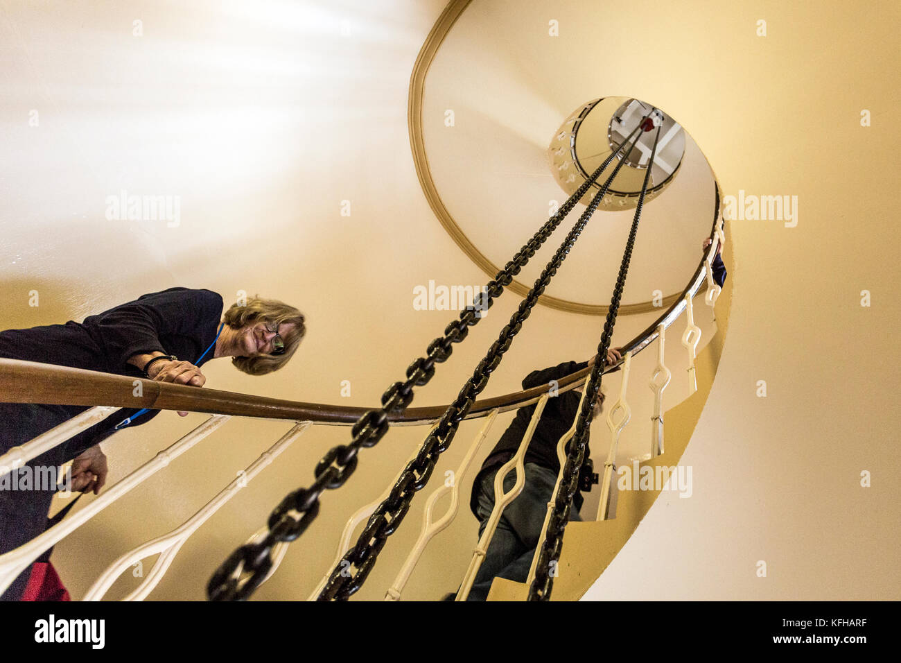 Chains that hold the clockwork weights for turning the lens inside ...