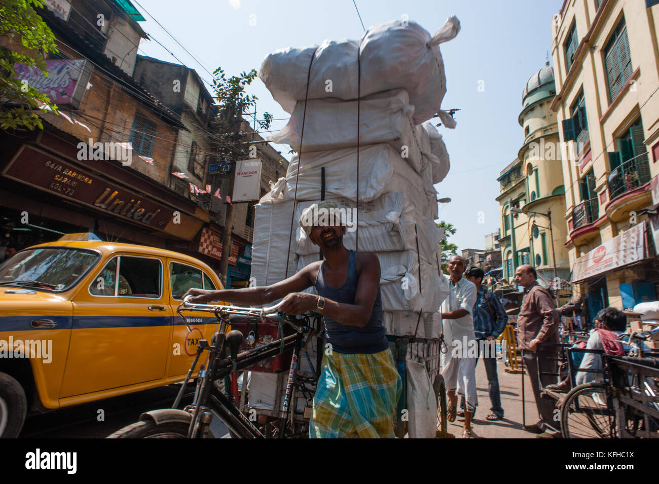 Man carrying goods in bicycle Stock Photo - Alamy