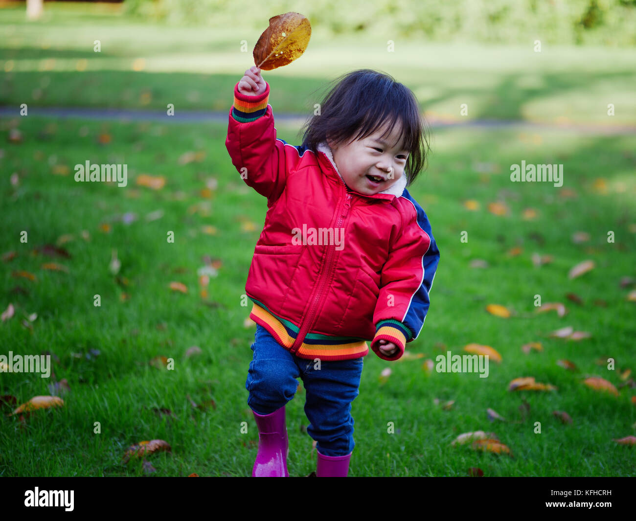 Baby girl playing at Autumn outdoor park Stock Photo - Alamy