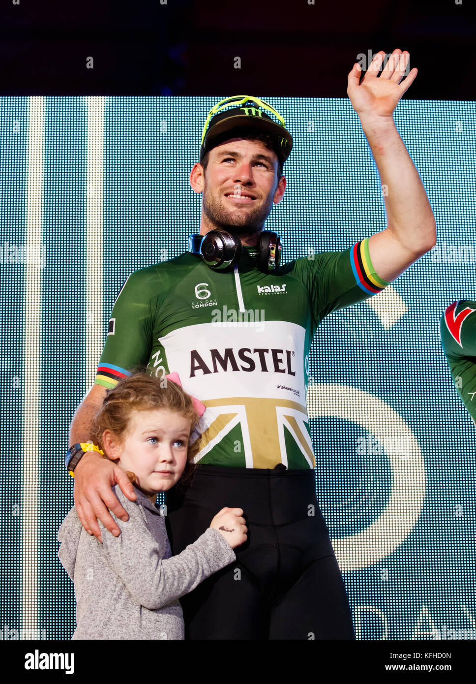 Great Britain's Mark Cavendish waves to the crowd with his daughter ...