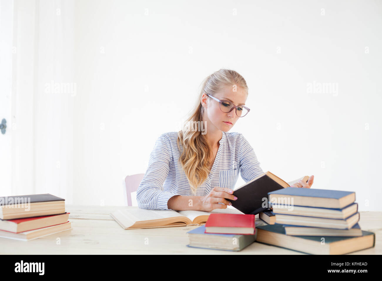 teacher in the Office preparing for the lesson many books Stock Photo ...