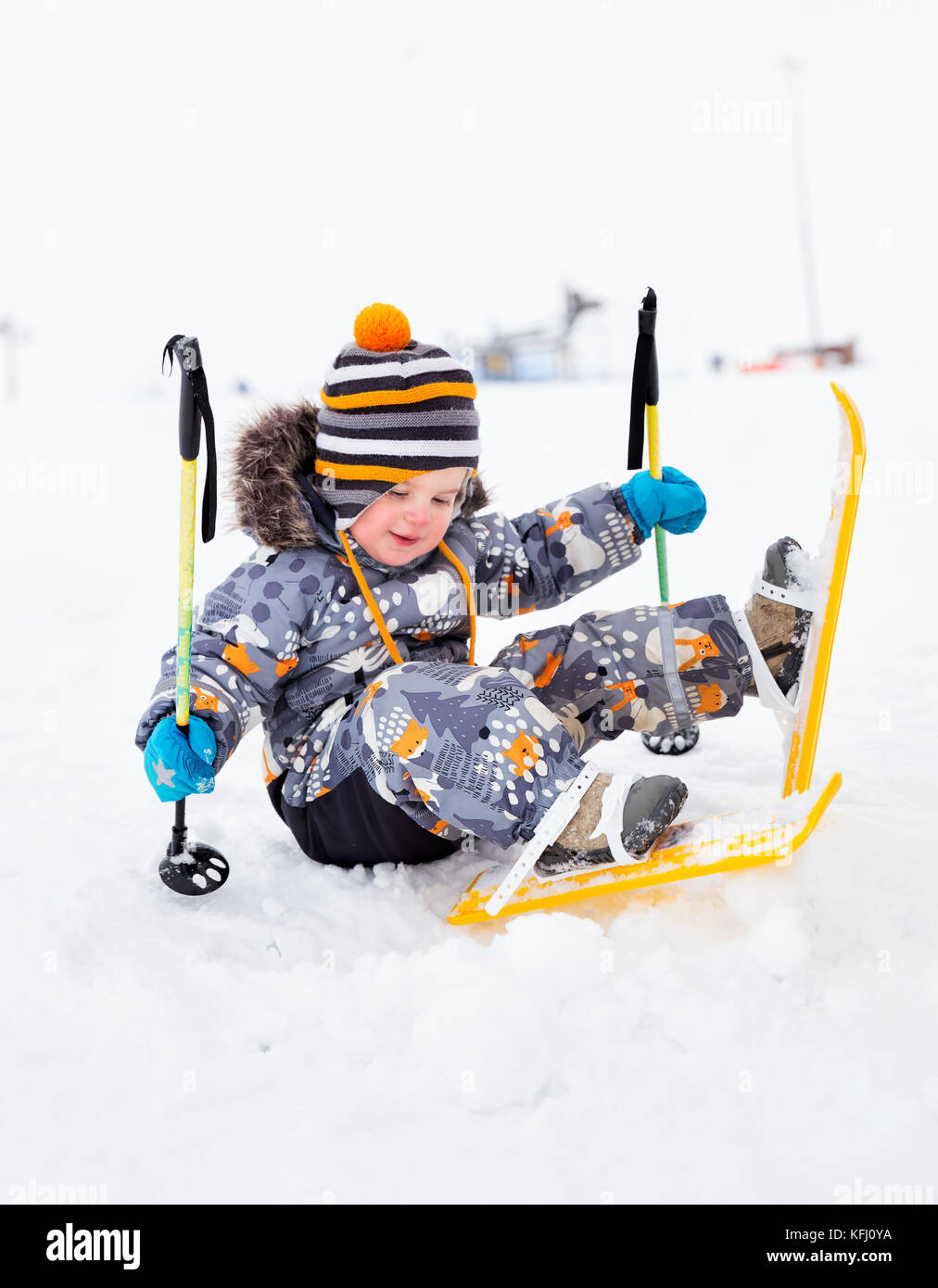 Small child, toddler 2,5 years, first time up on skis and fell Stock ...