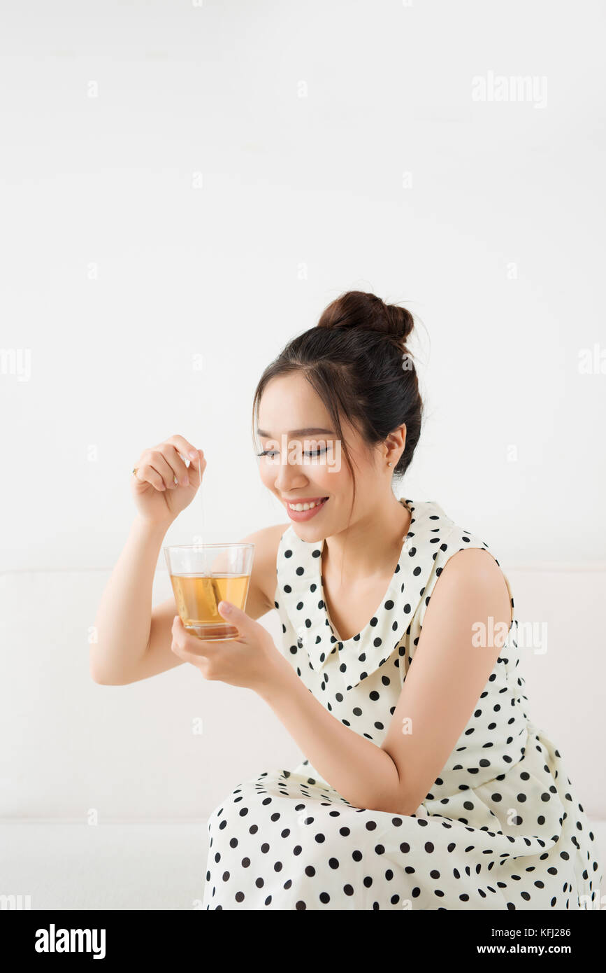 Young attractive asian woman drinking hot tea Stock Photo - Alamy