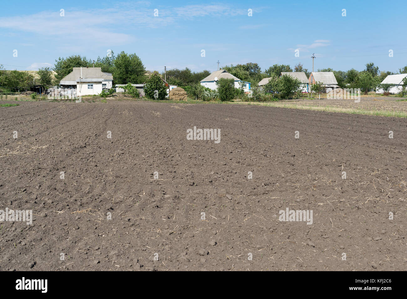 Tillage on the land near the village house Stock Photo - Alamy