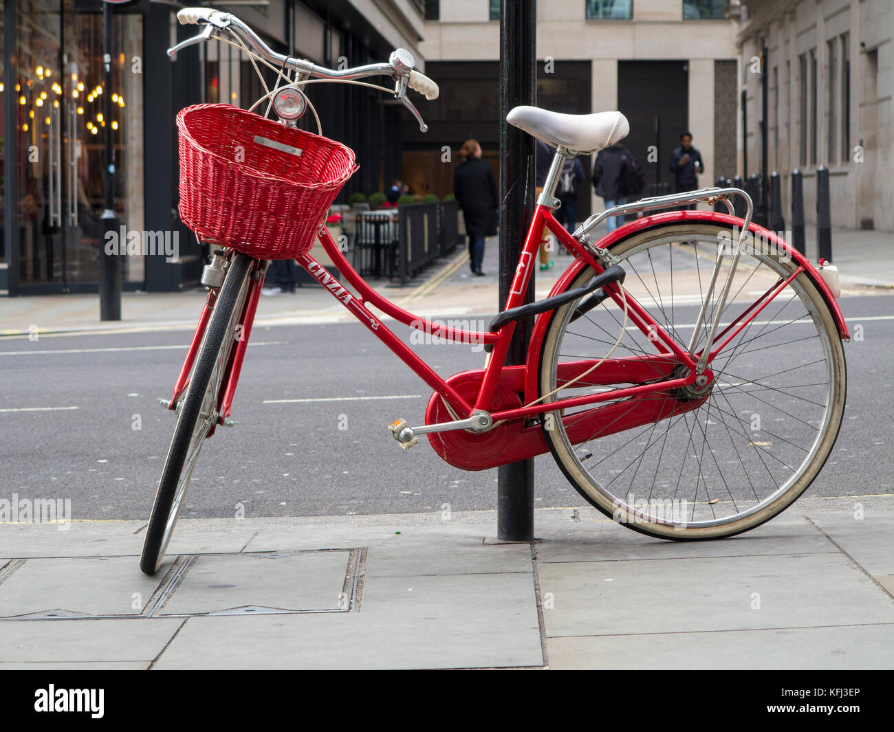 An elegant lady's red bicycle chained to a lampost in central London ...