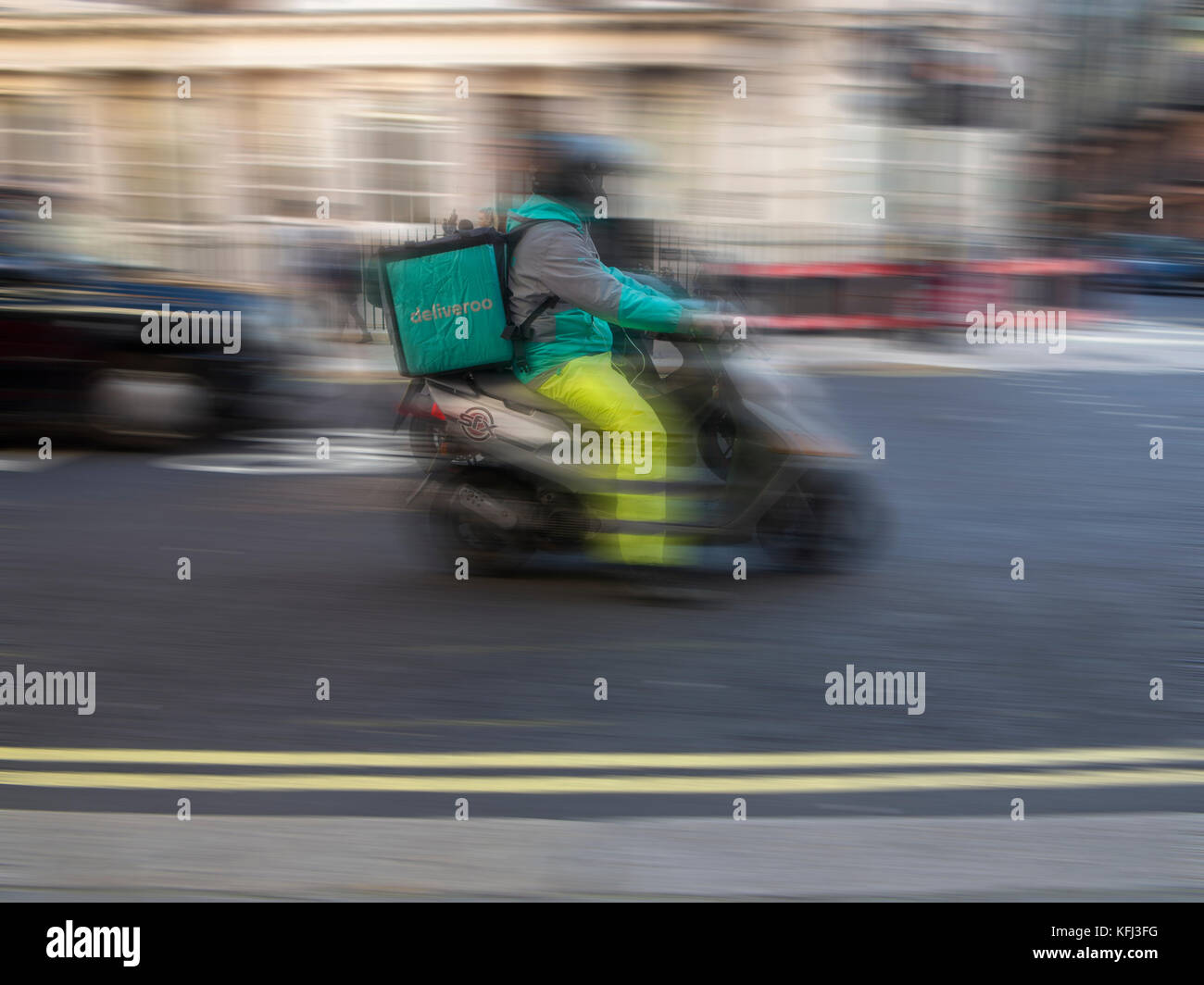 A Deliveroo rider delivers some takeaway food on a moped Stock Photo ...