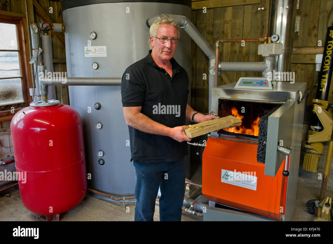 Chris Chilcott with his wood burning boiler at his home in Cornwall ...