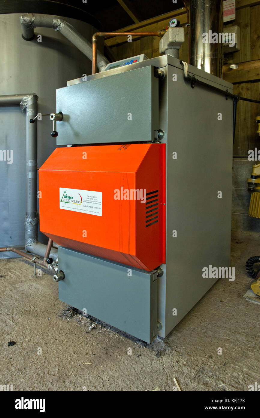 Chris Chilcott with his wood burning boiler at his home in Cornwall ...