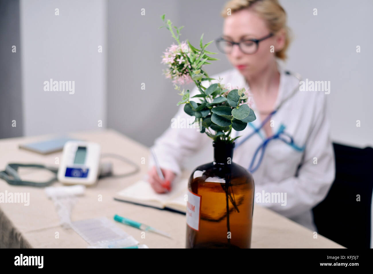The doctor makes notes in the diary Stock Photo - Alamy