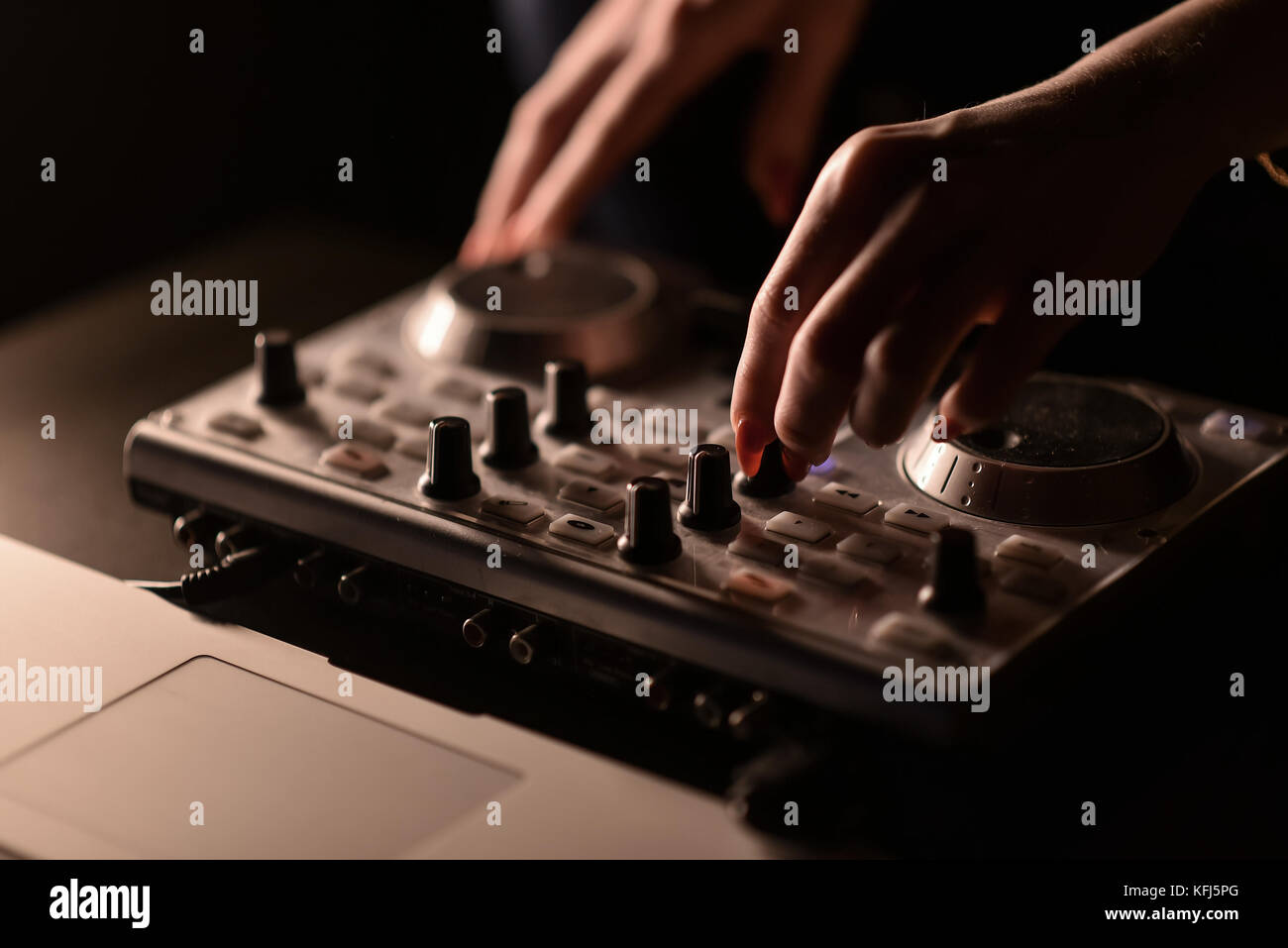 DJ mixer disco illuminated by searchlights Stock Photo - Alamy