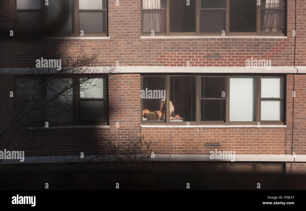 Exhibitionist Couple Having Sex In An Apartment Building Window Stock