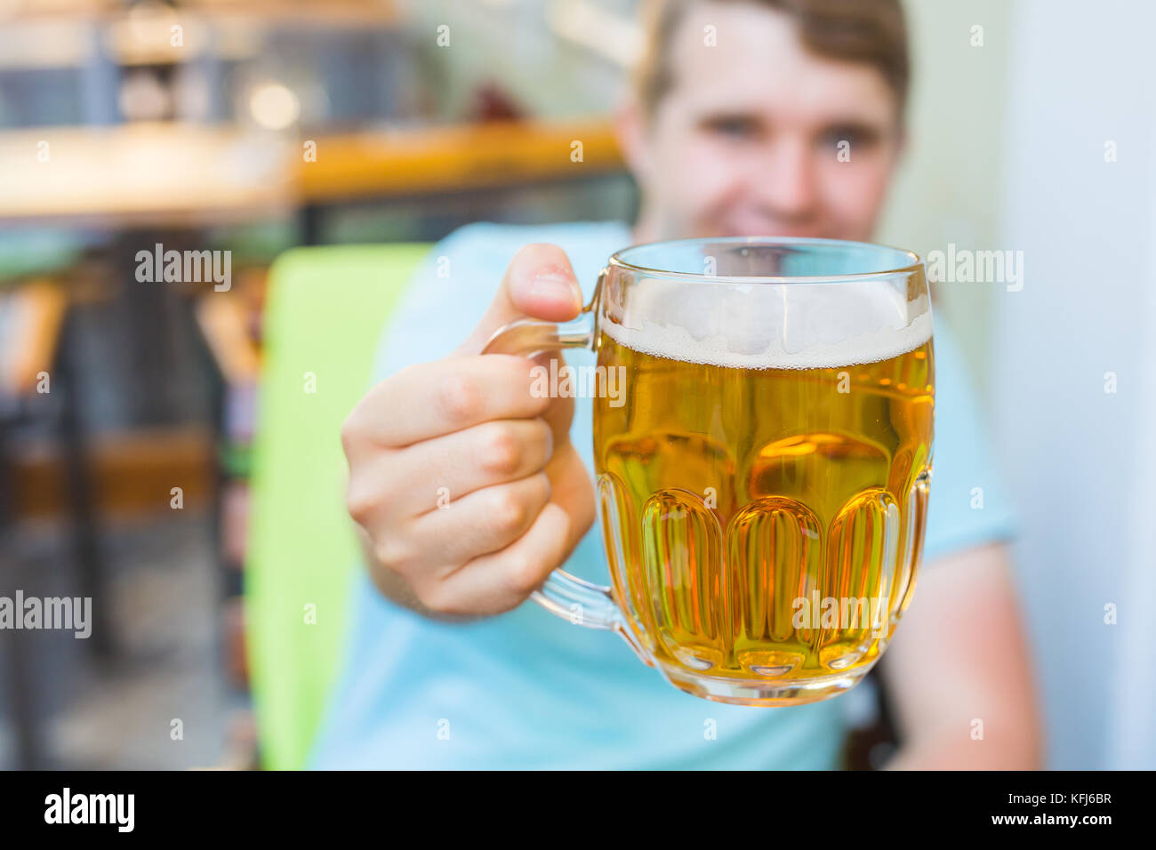 joyful smiling man holding a large beer mug outdoor Stock Photo - Alamy