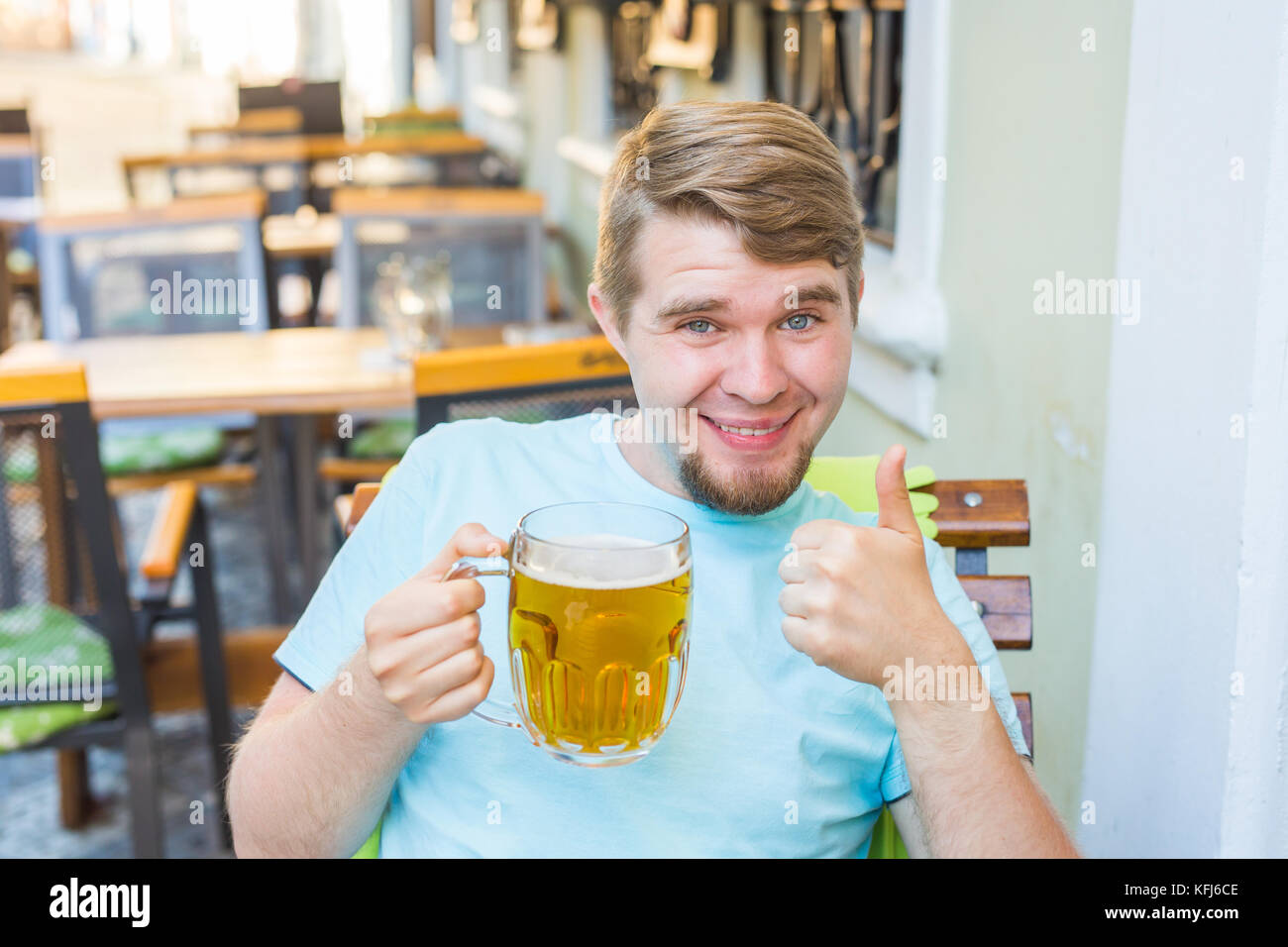 people, drinks, alcohol, gesture and leisure concept - happy young man ...