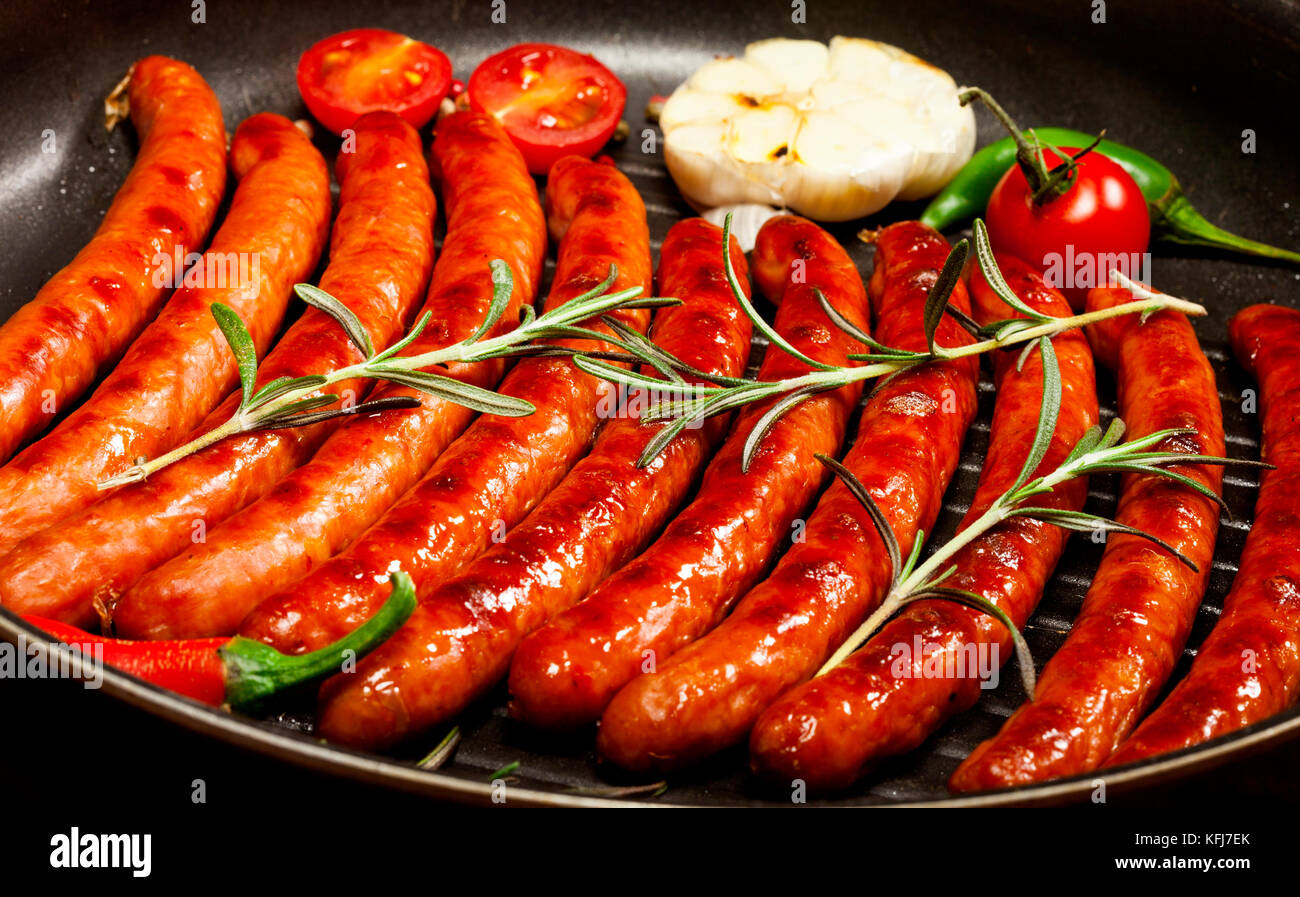 Closeup of Wiener Sausages with vegetables in a pan Stock Photo - Alamy