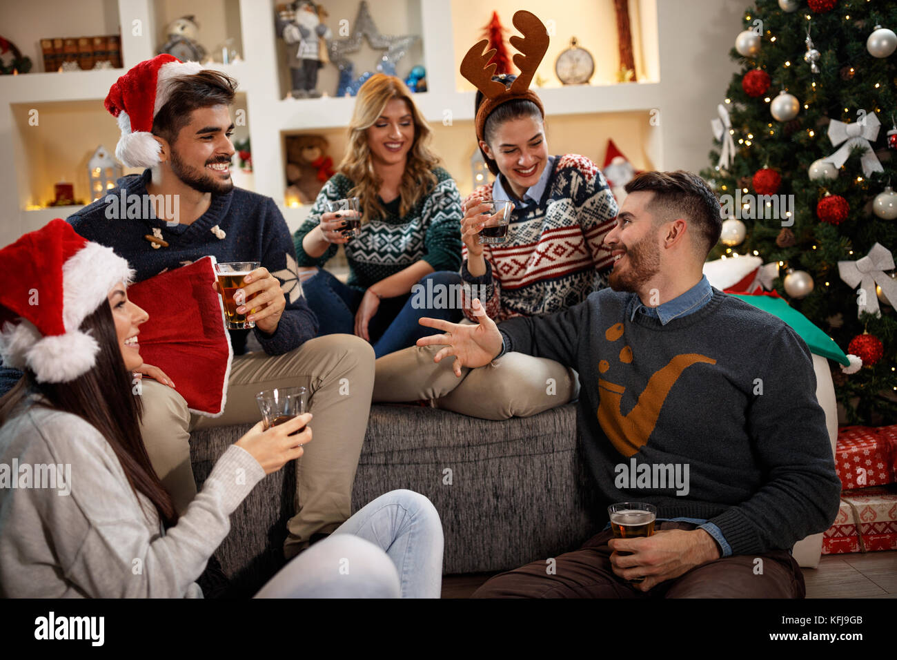 Group of happy friends having fun together in Christmas eve Stock Photo ...