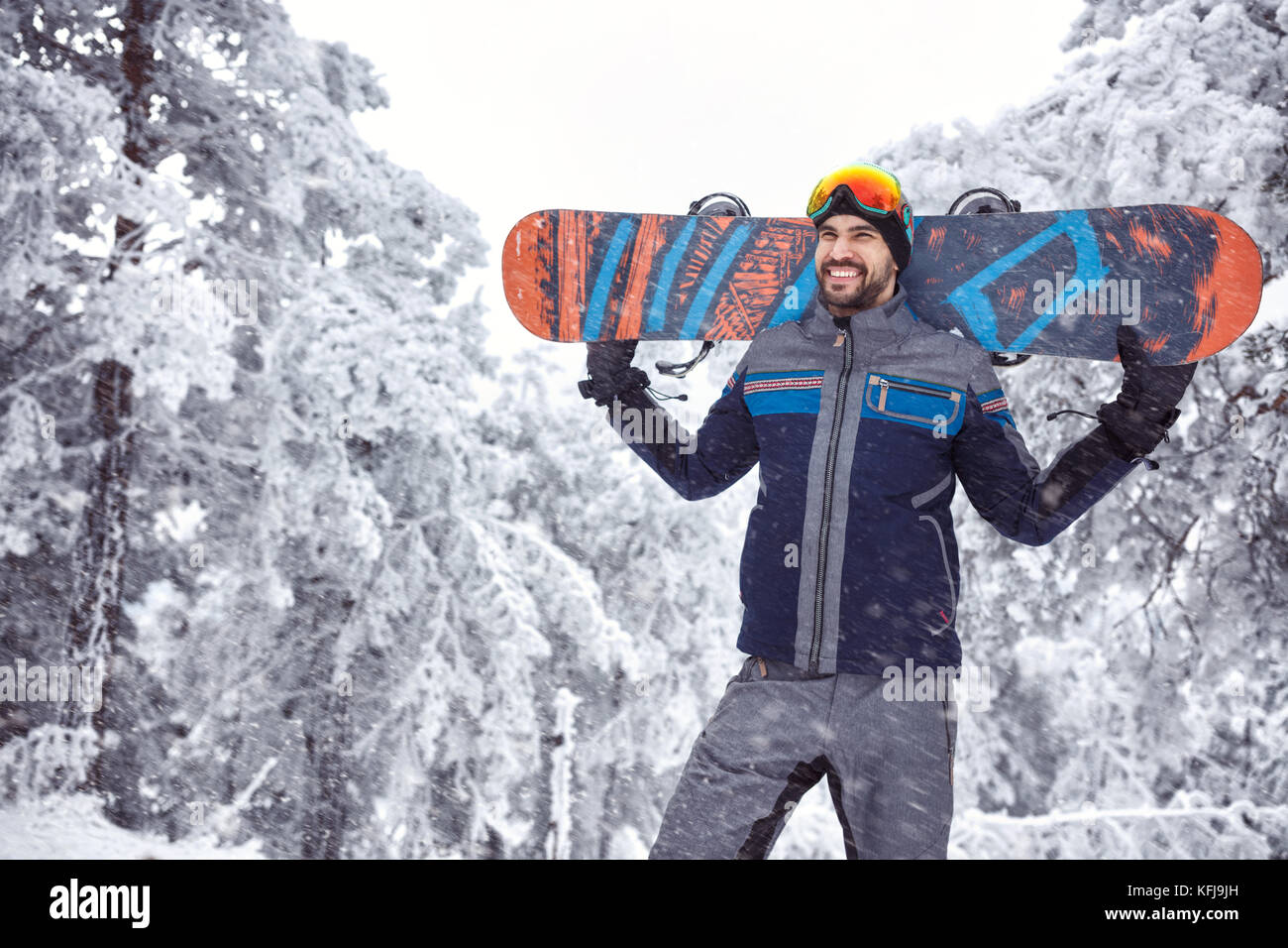 smiling handsome male snowboarder on the mountain Stock Photo - Alamy