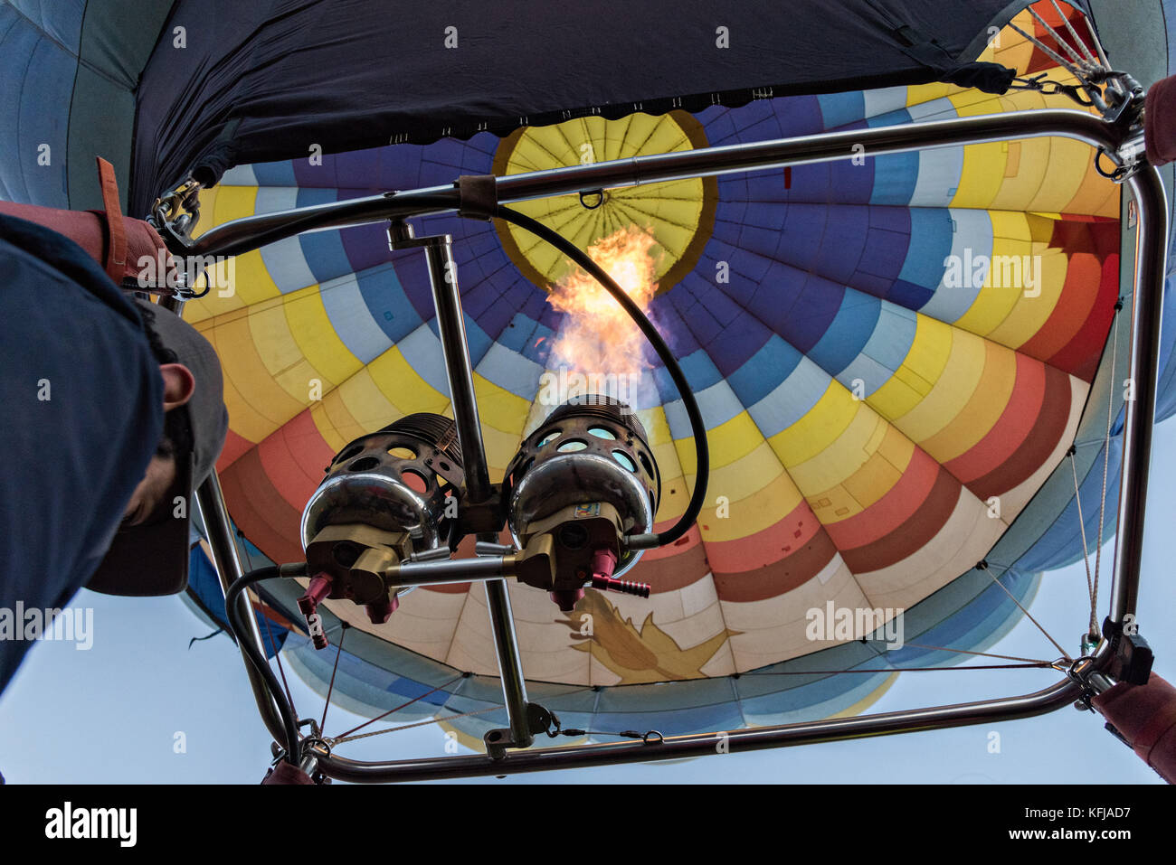 Flames shoot hot air into a balloon as it begins ascending over the ...