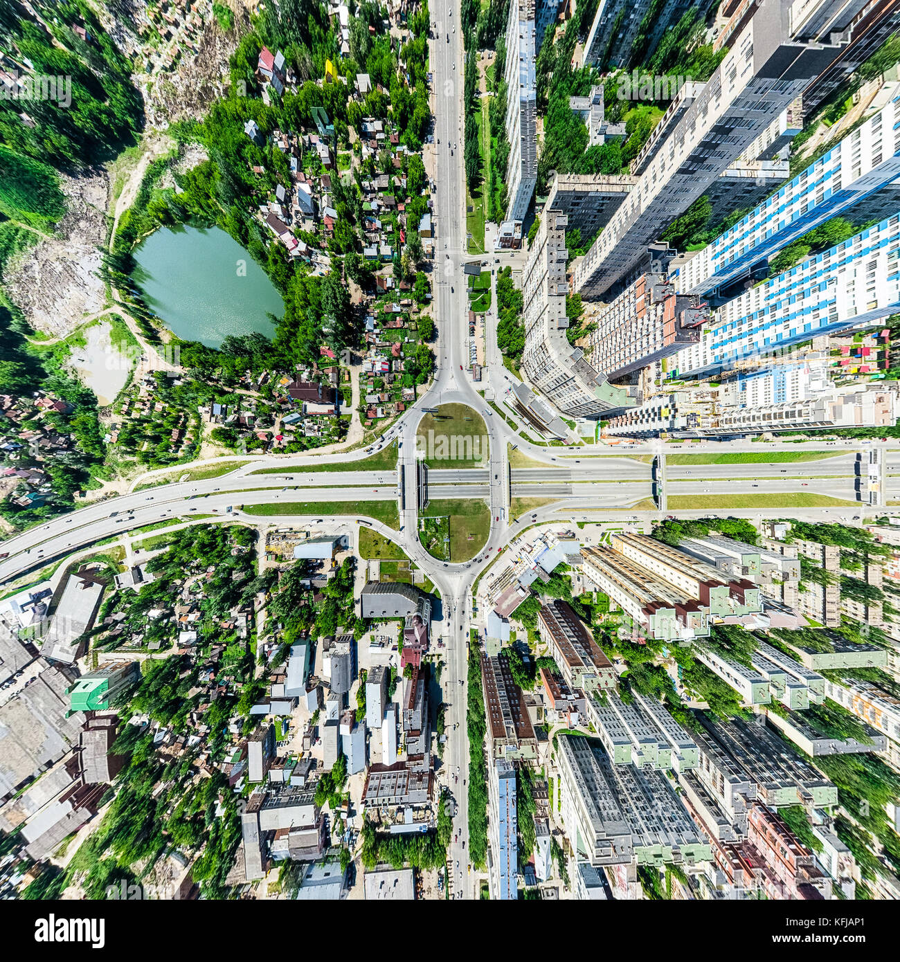 Aerial city view with crossroads and roads, houses, buildings, parks ...