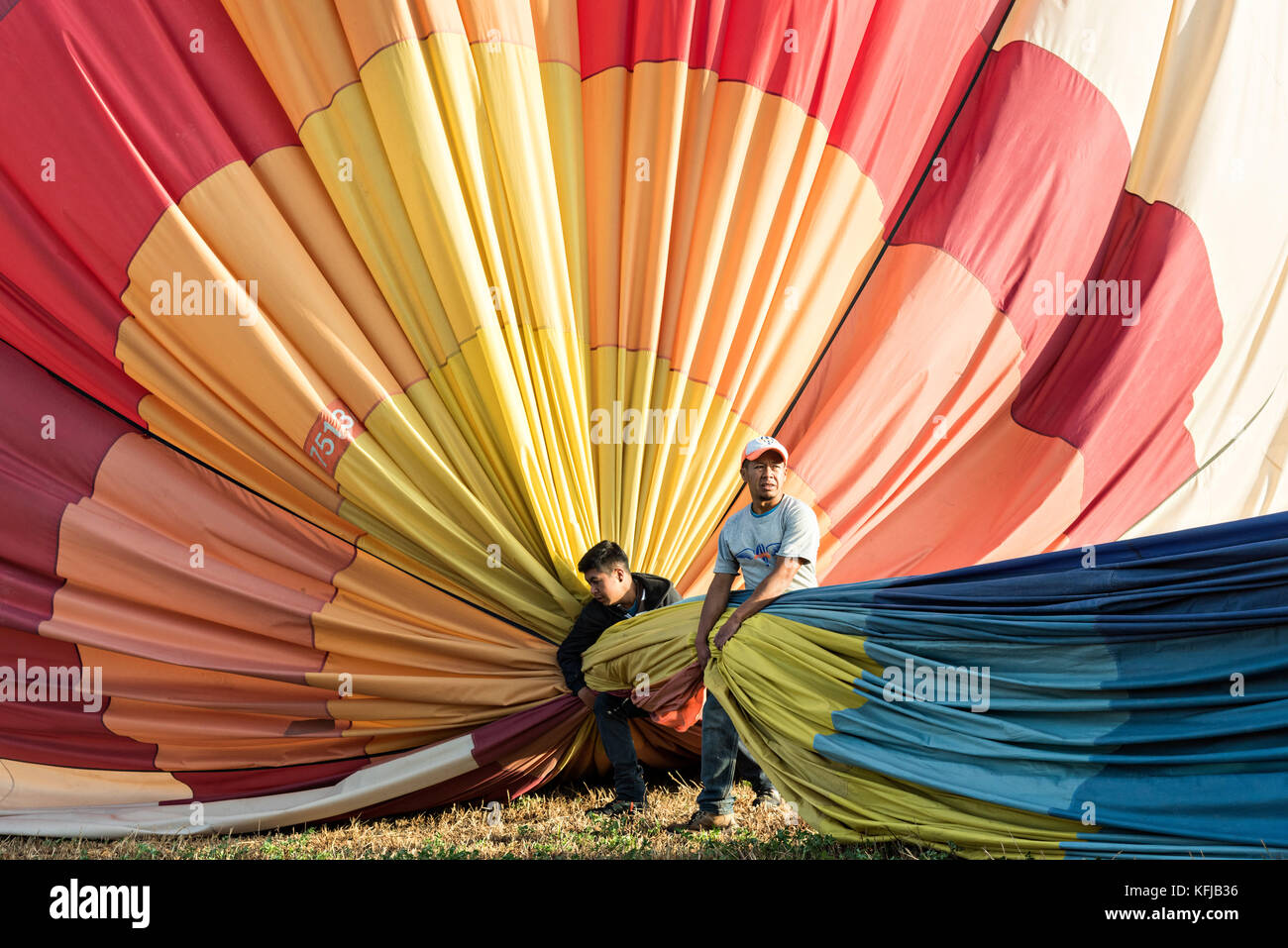 Ground crew begin deflating and securing a hot air balloon after ...