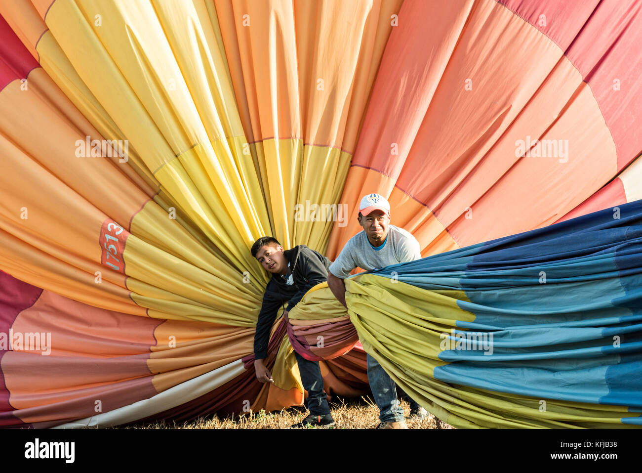 Ground crew begin deflating and securing a hot air balloon after ...