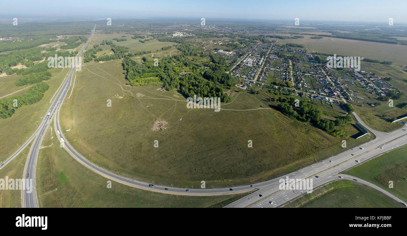 Aerial city view with crossroads, roads, houses, buildings, parks ...