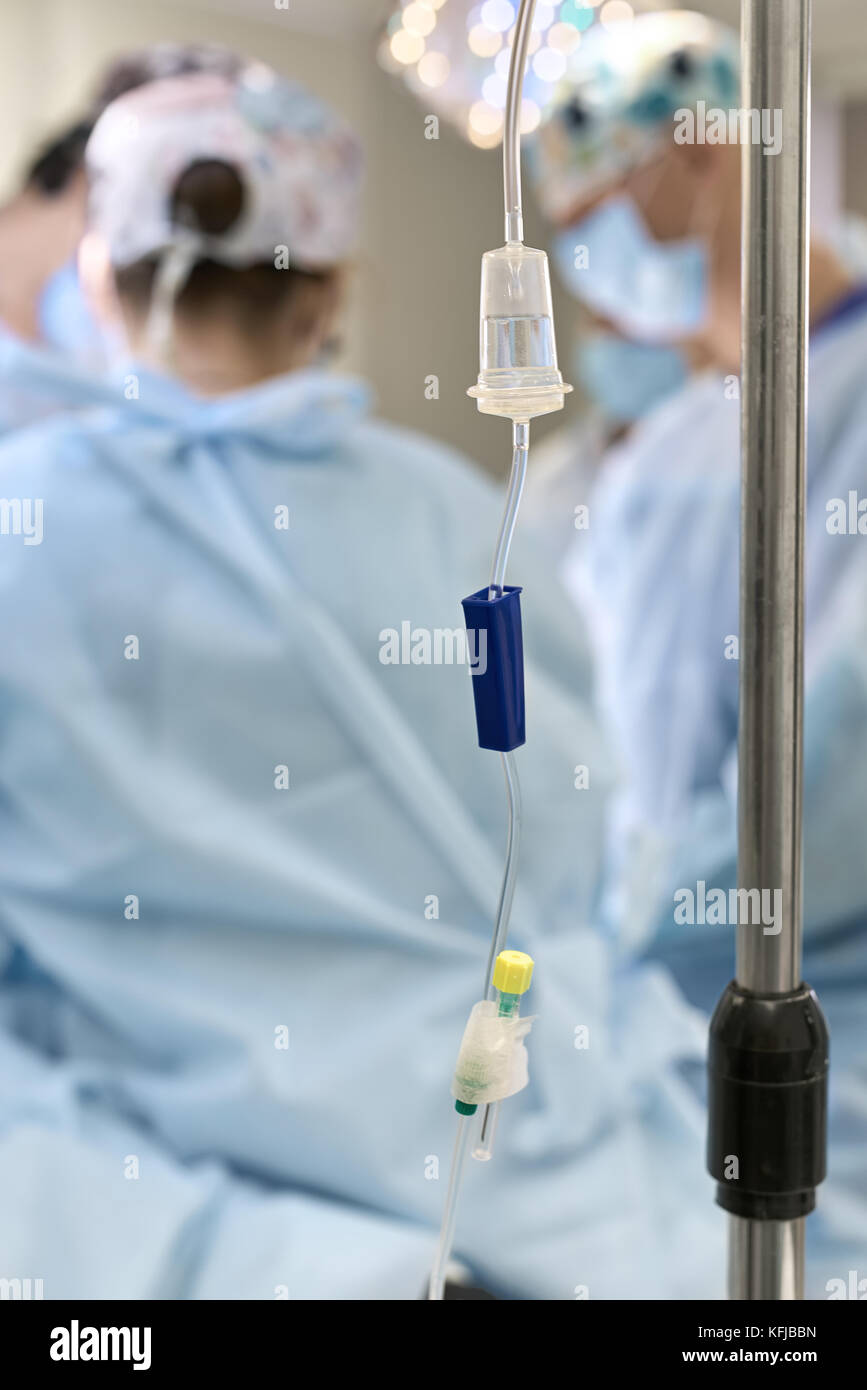 Medical drop counter on the blurry background of the group of doctors ...