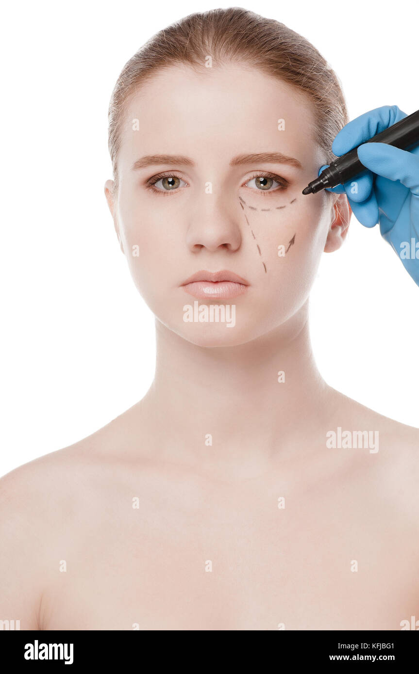 Beautician draw correction lines on woman face Stock Photo - Alamy